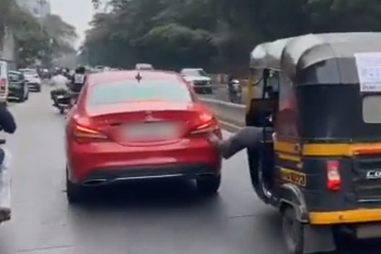 Mercedes stuck in road, auto-rickshaw driver pushes it with leg